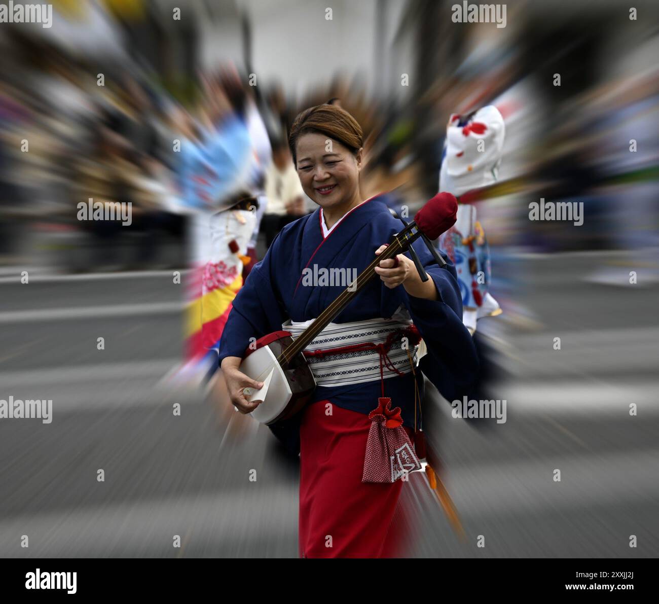 Female Japanese musician playing the traditional Shamisen at Himeji ...