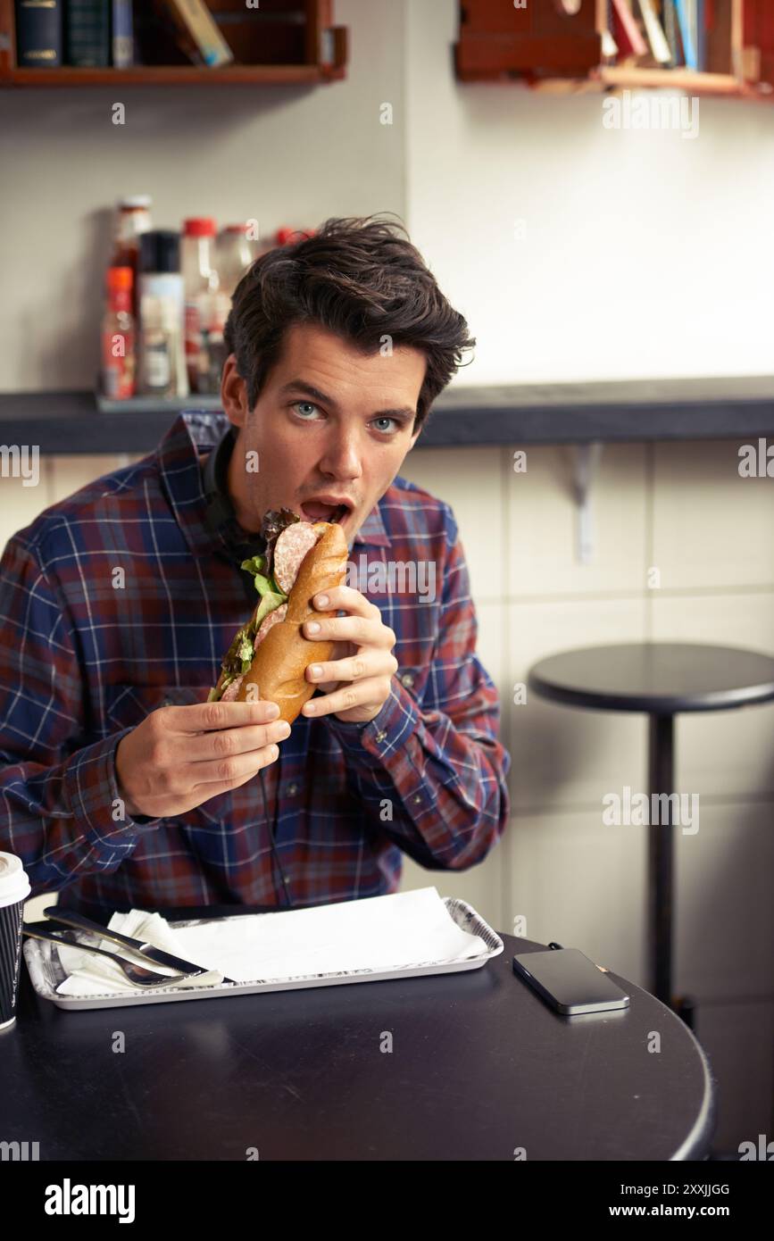 Lunch, portrait and sandwich with man at restaurant for meal, nutrition ...