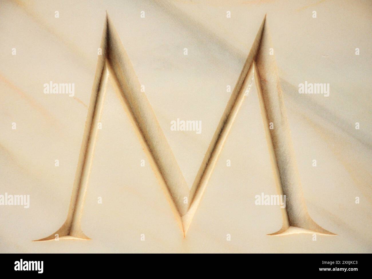 Capital letter M of the Latin alphabet engraved on marble Stock Photo ...