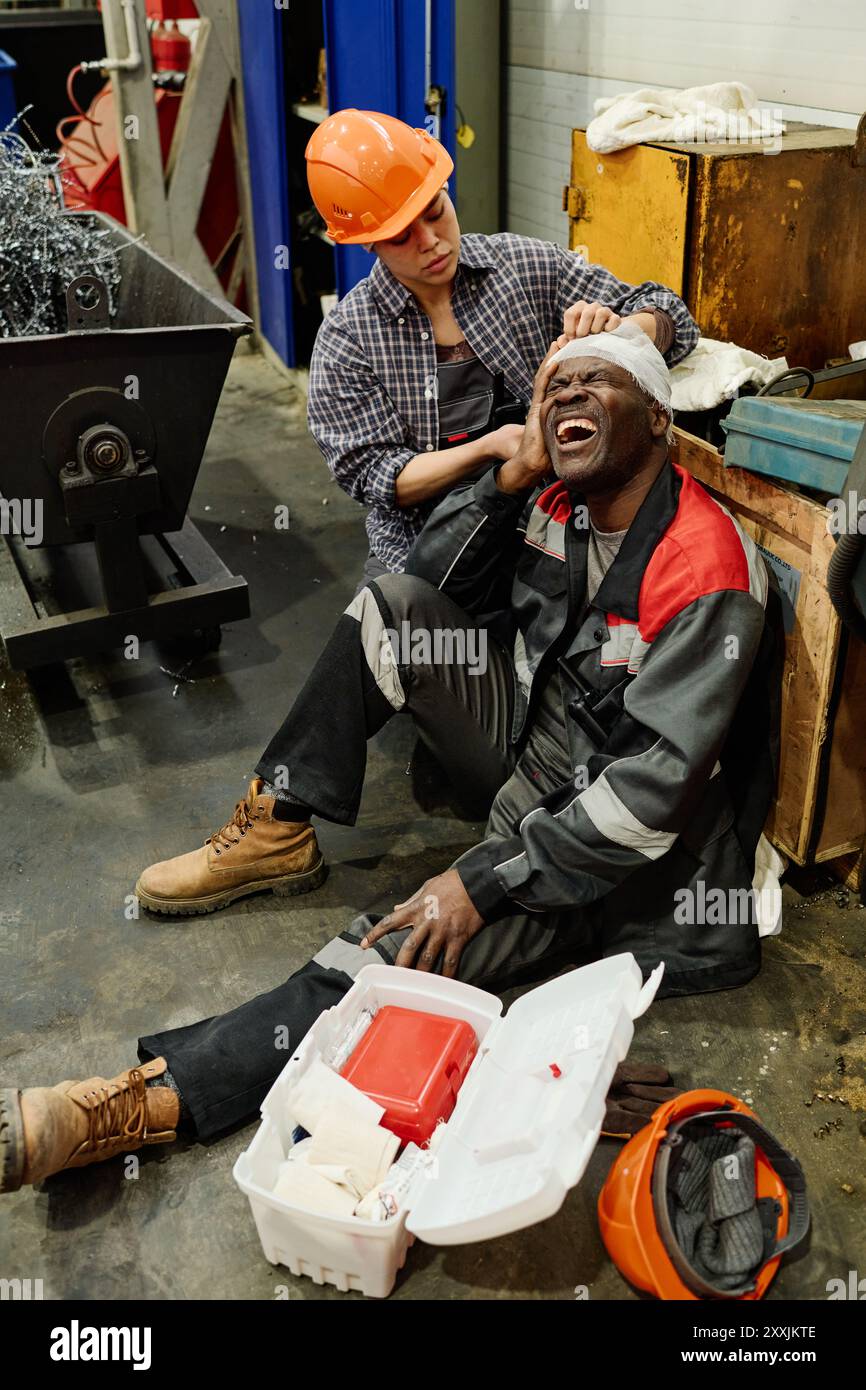 Image showing person assisting injured worker in construction site ...