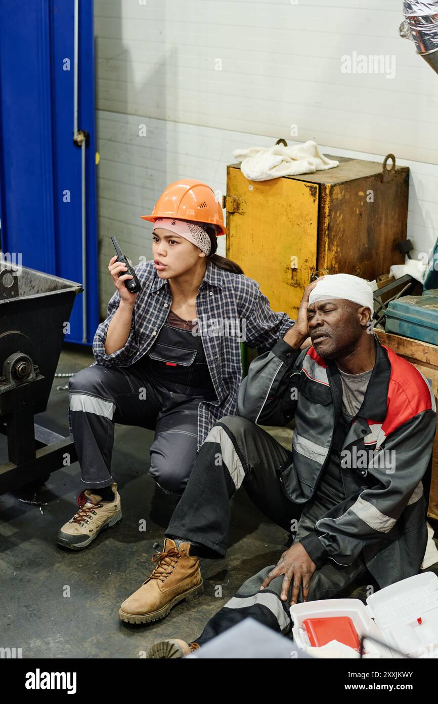 Construction workers wearing protective gear and communicating with ...