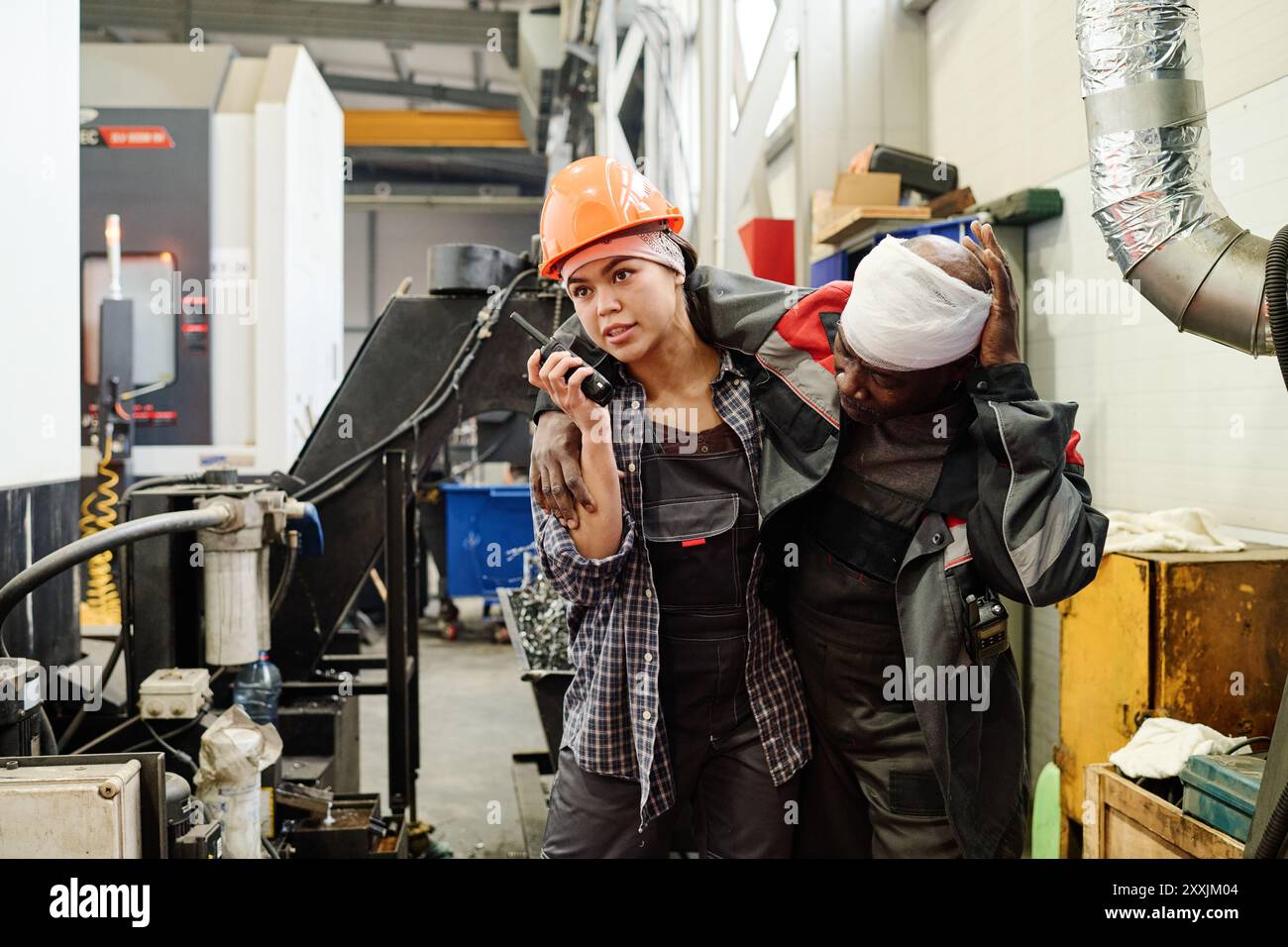 Construction workers in industrial environment showing teamwork and ...