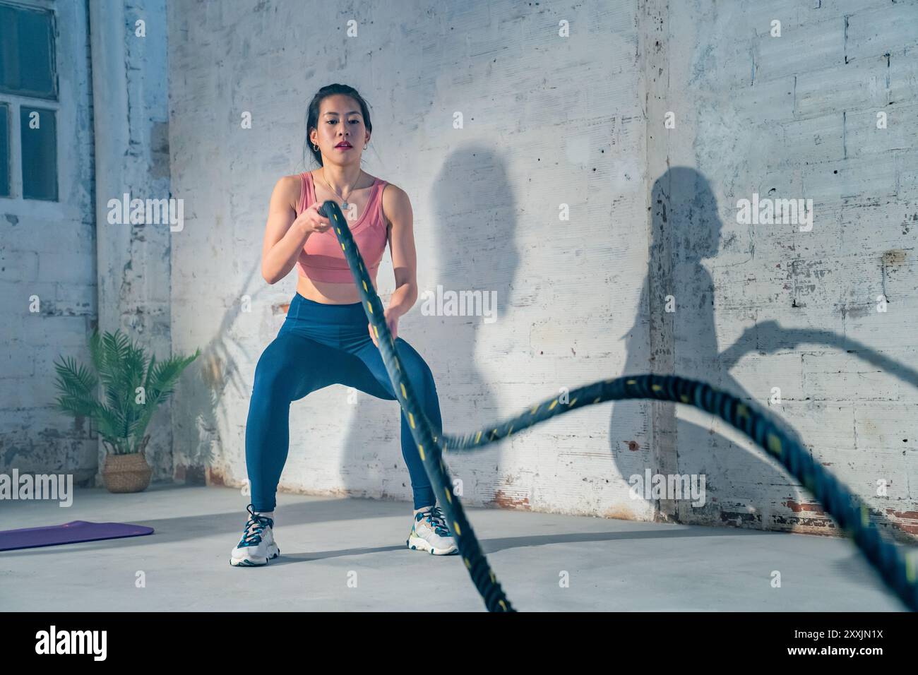 Fitness Chinese athlete training using battle ropes intense workout ...