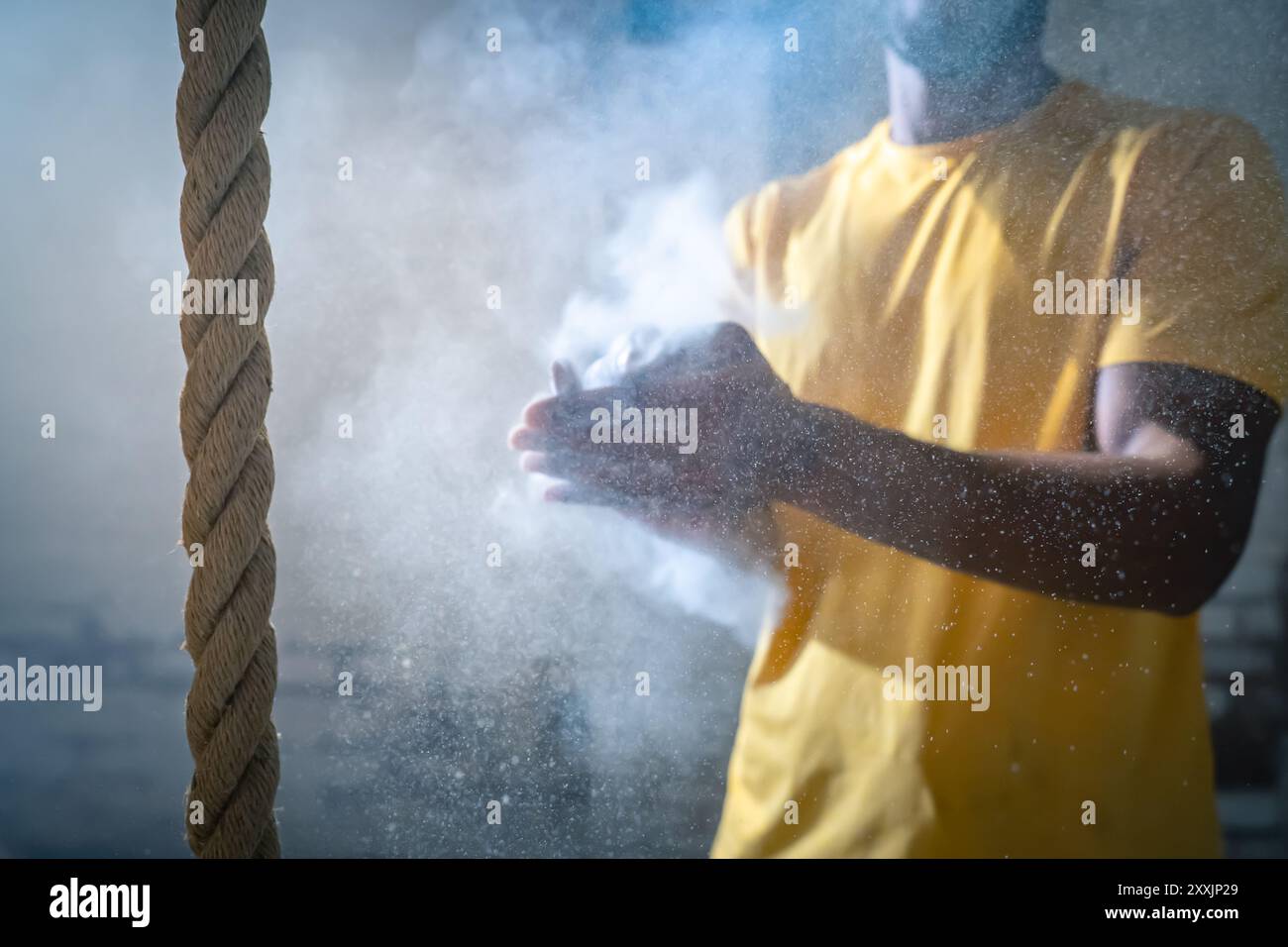 Strong fit muscular fitness man putting magnesium sports chalk powder ...