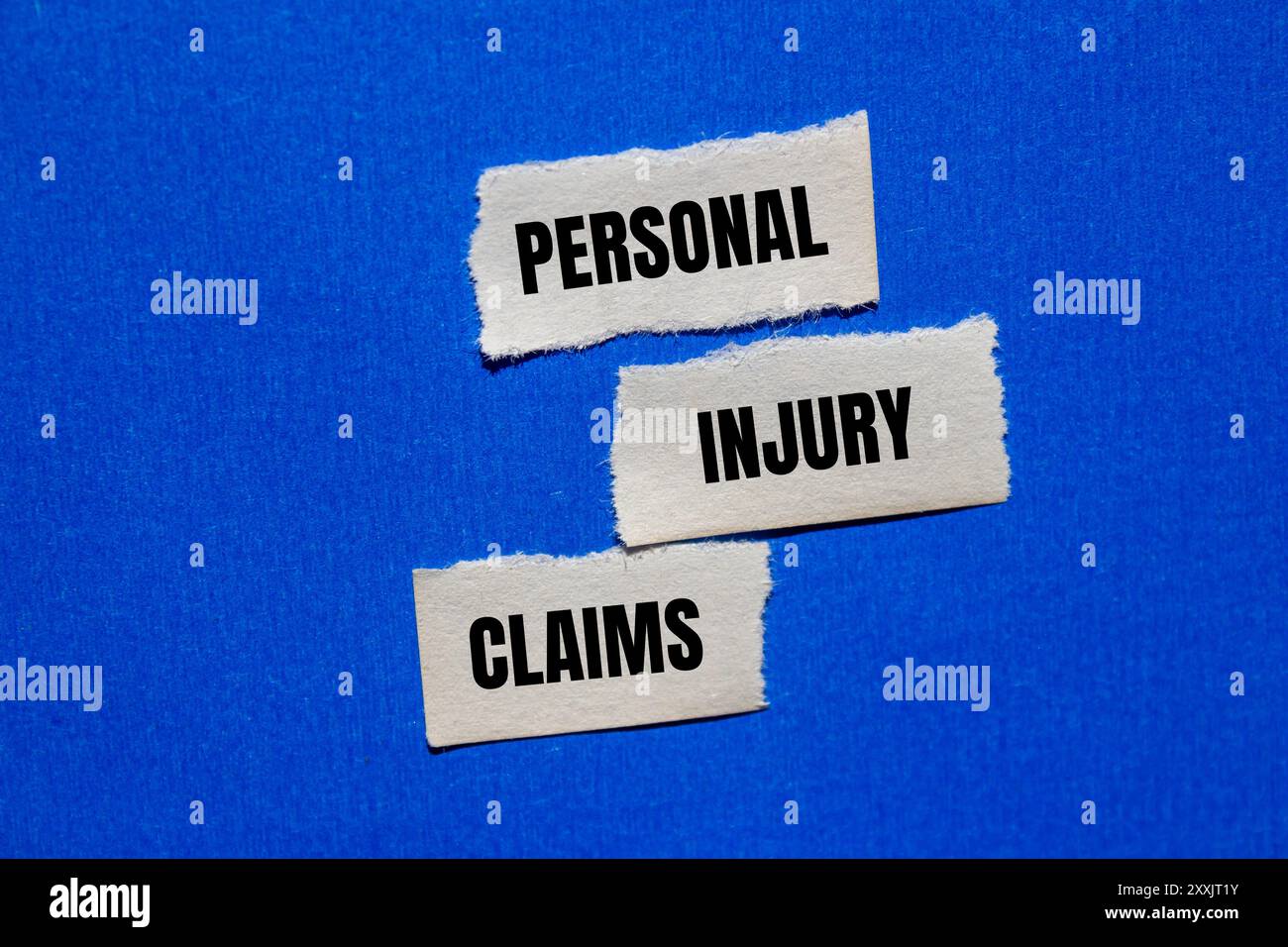 Personal injury claims message written on ripped torn paper peices with ...