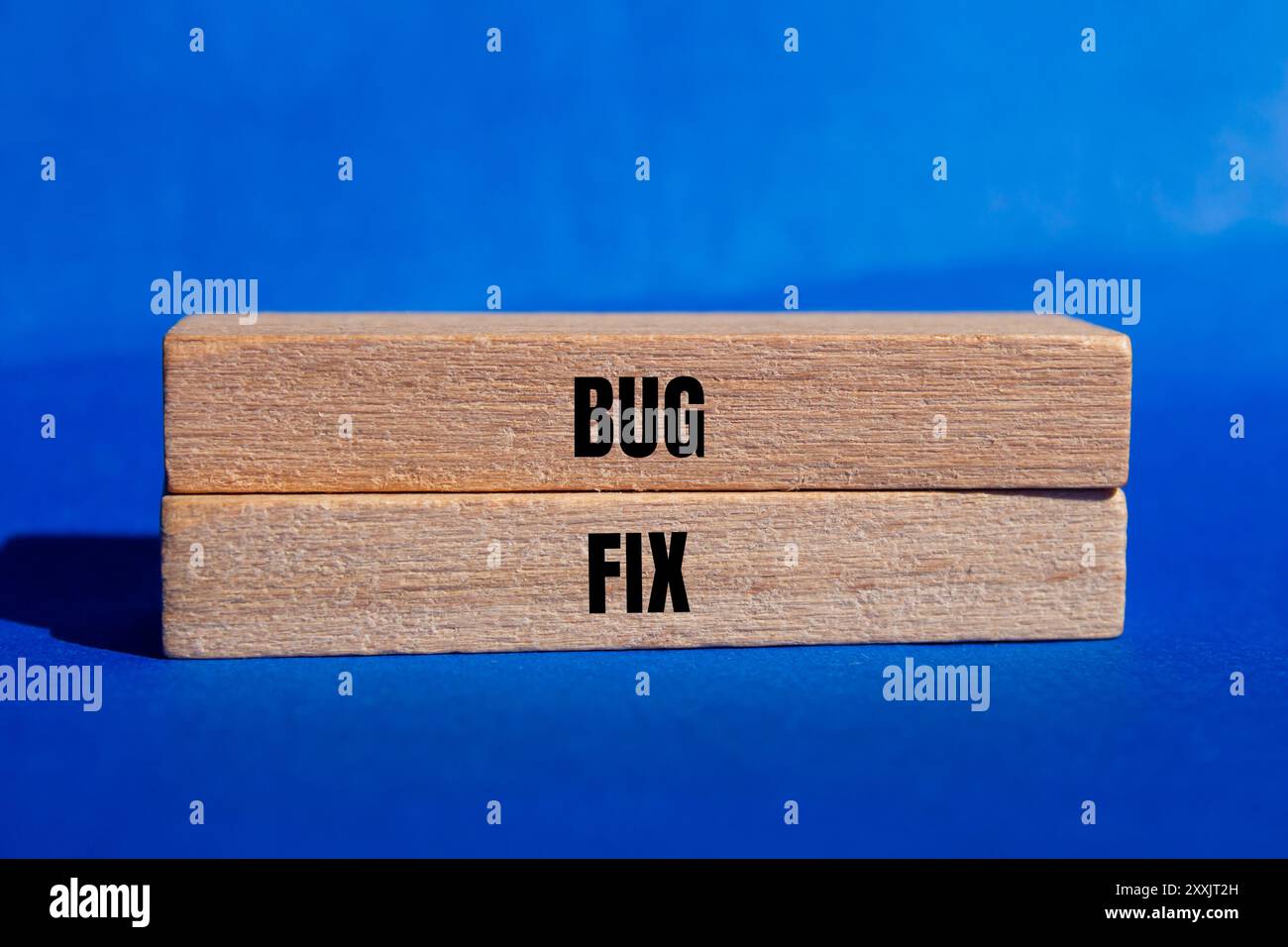 Bug fix message written on wooden blocks with blue background ...