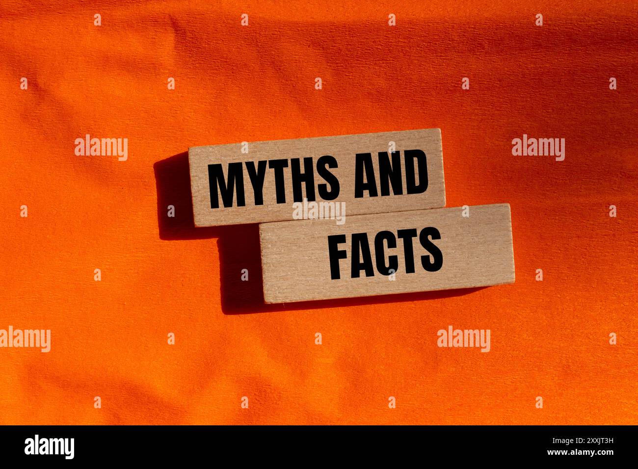 Myths and facts message written on wooden blocks with orange background ...