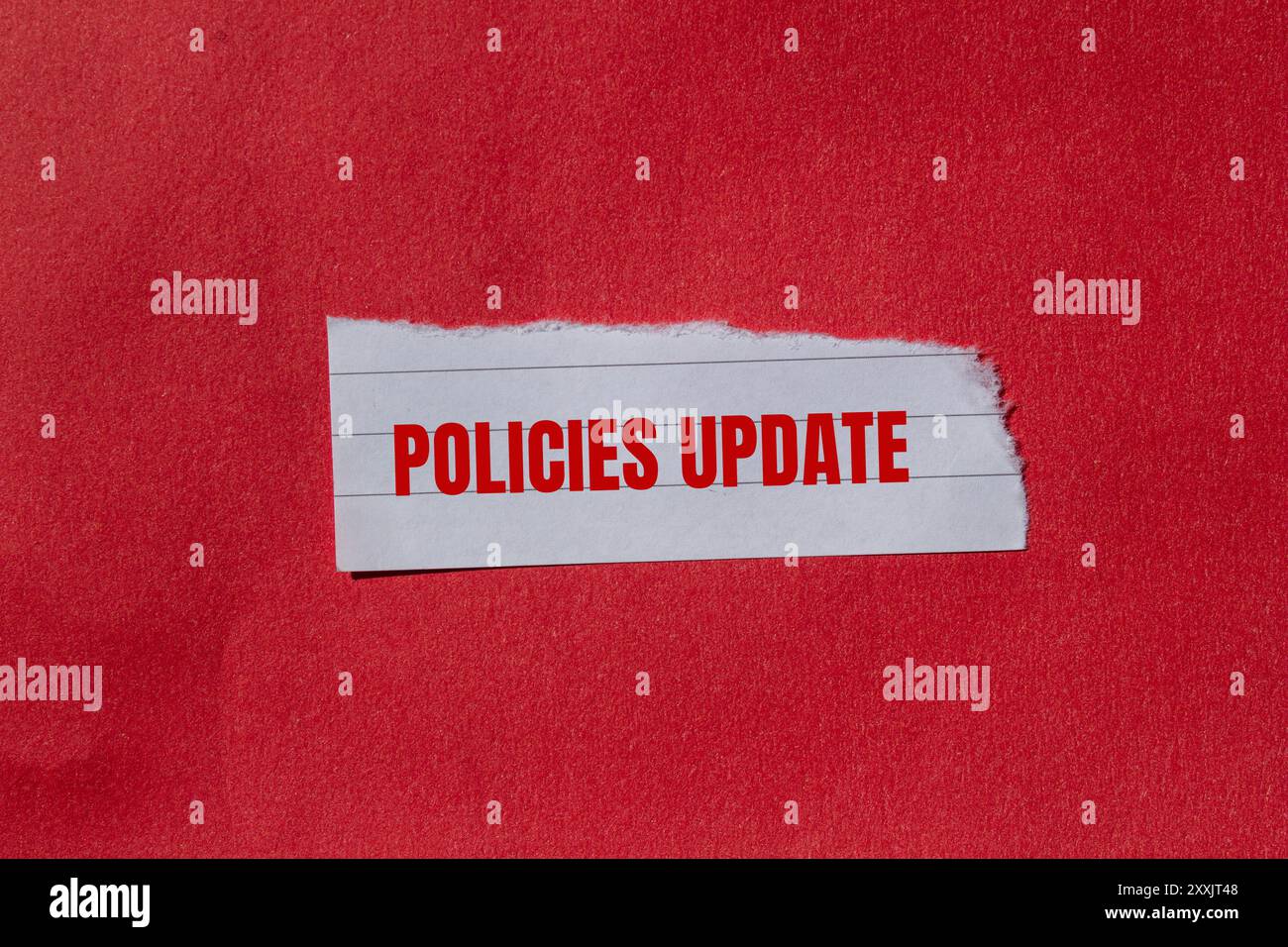 Policies update message written on ripped torn paper piece with red background. Conceptual ...