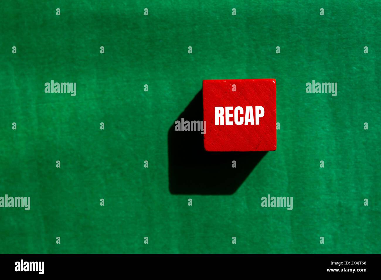 Recap message written on red wooden cube with green background. Conceptual recap symbol. Copy ...