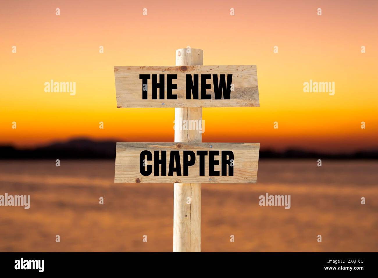 The new chapter message written on wooden sign with blurry lake ...