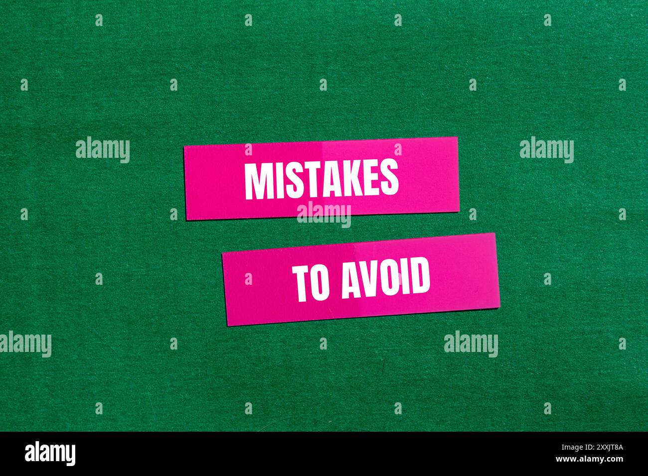 Mistakes to avoid message written on pink paper with green background ...