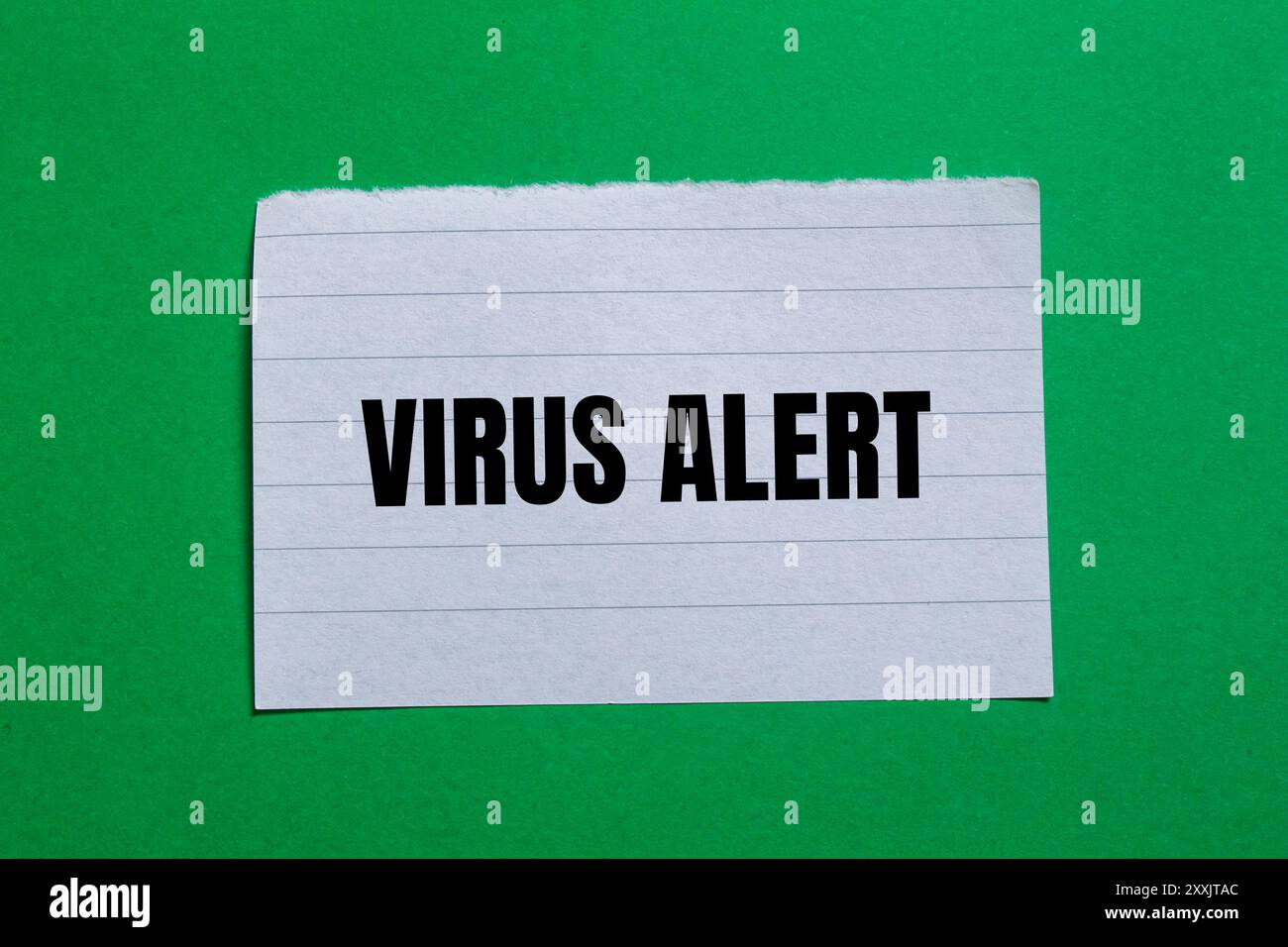 Virus alert message written on ripped torn paper piece with green ...