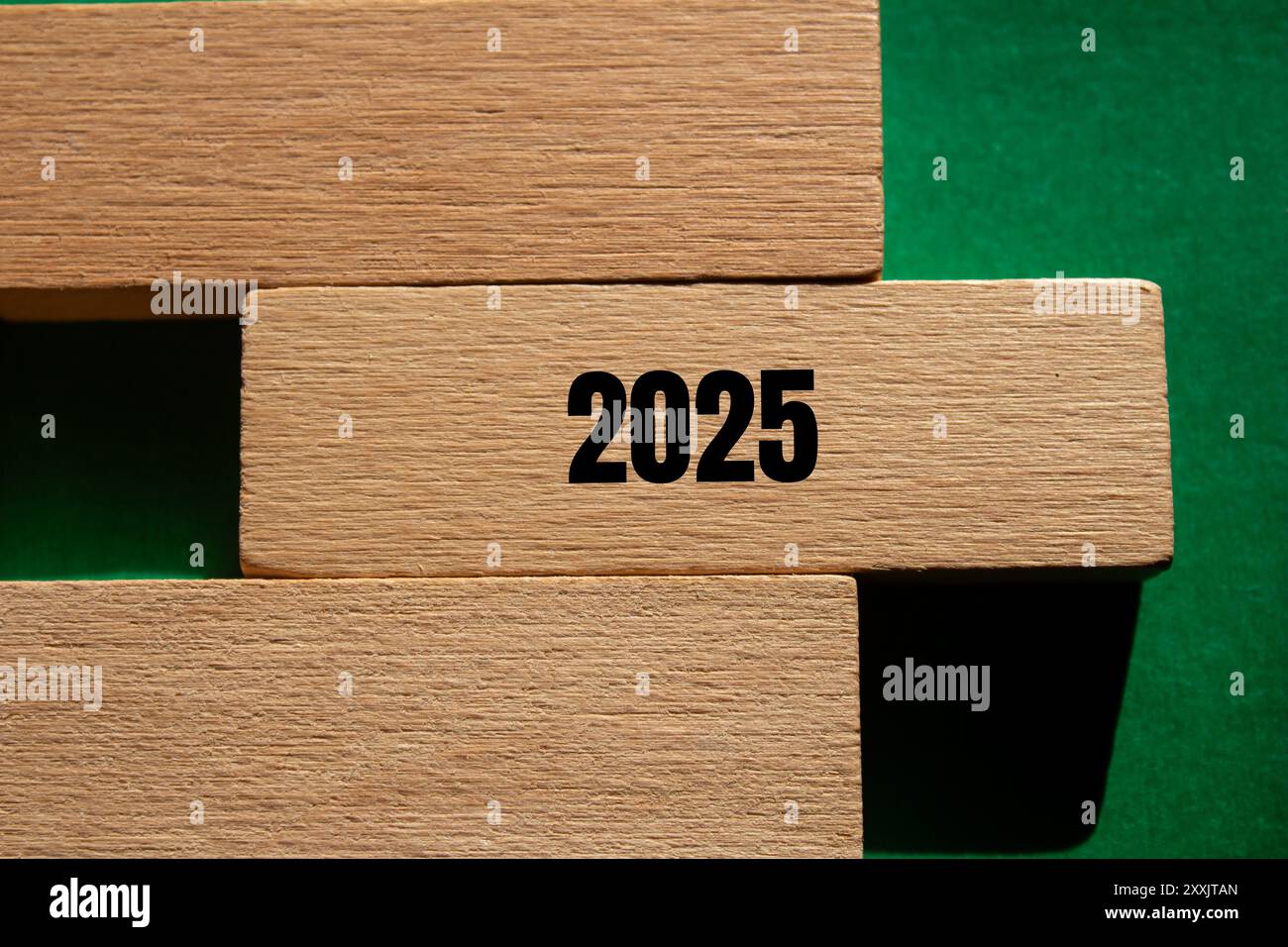 2025 message written on wooden block with green background. Conceptual 2025 symbol. Copy space ...