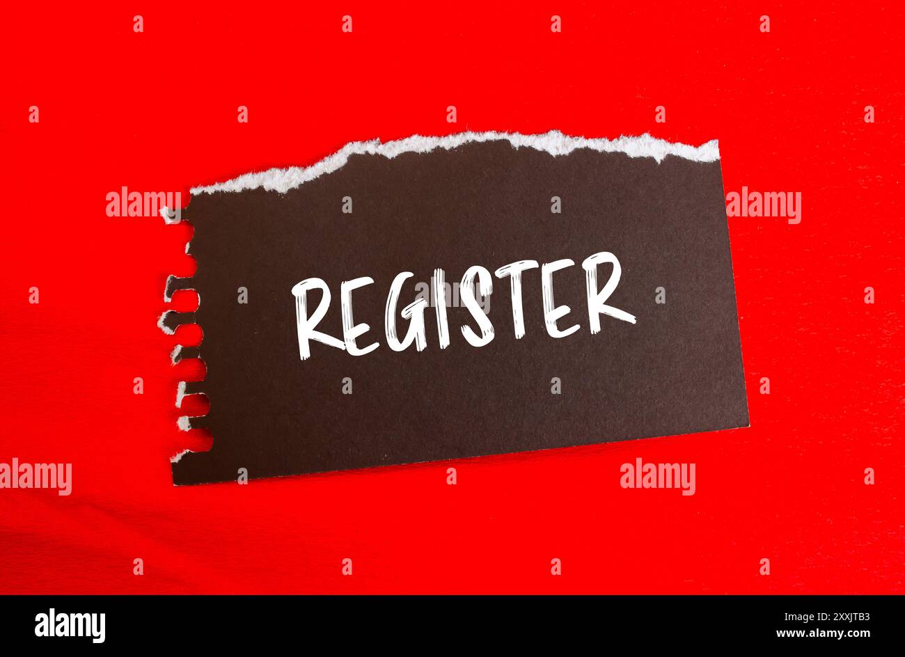Register message written on ripped torn black paper piece with red ...
