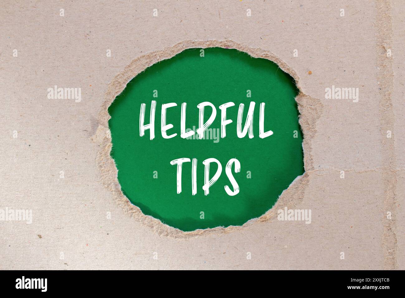Helpful tips message written on ripped torn paper with green background ... Helpful tips message written on ripped torn paper with green background ...