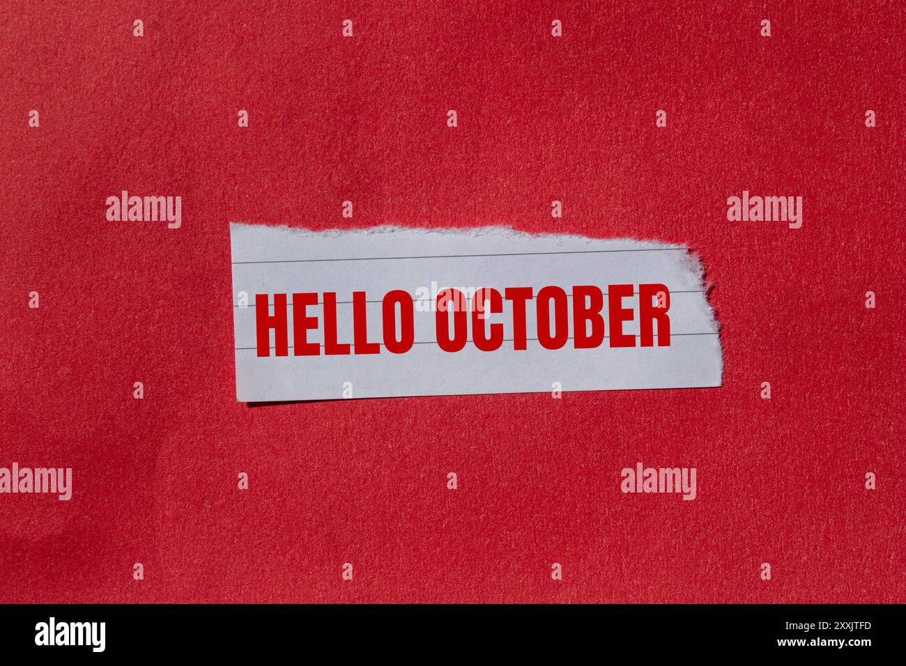 Hello october message written on ripped torn paper piece with red ...