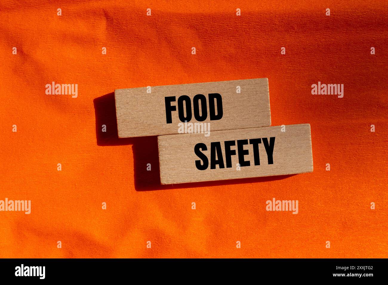 Food safety message written on wooden blocks with orange background ...