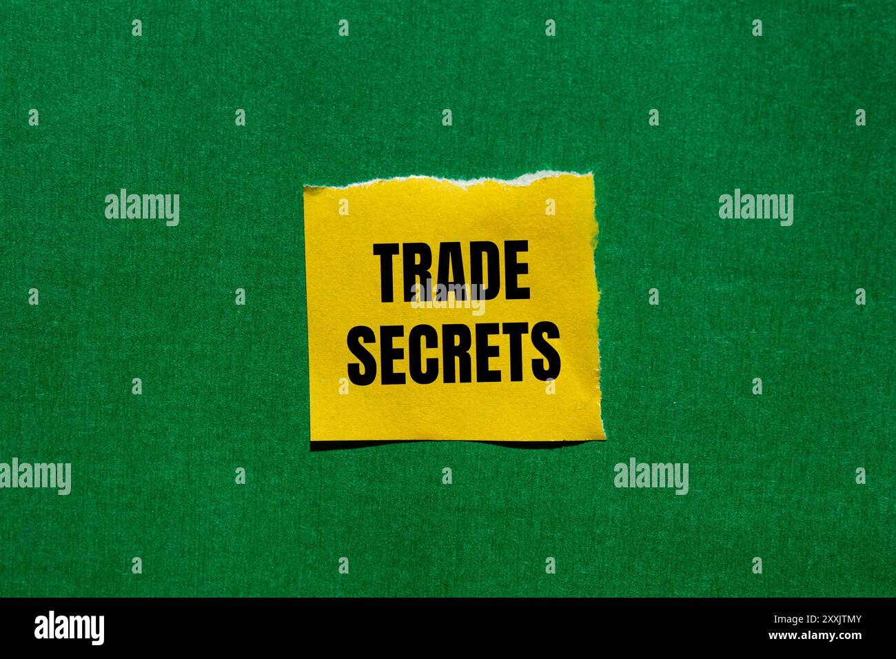 Trade secrets message written on ripped torn yellow paper piece with ...