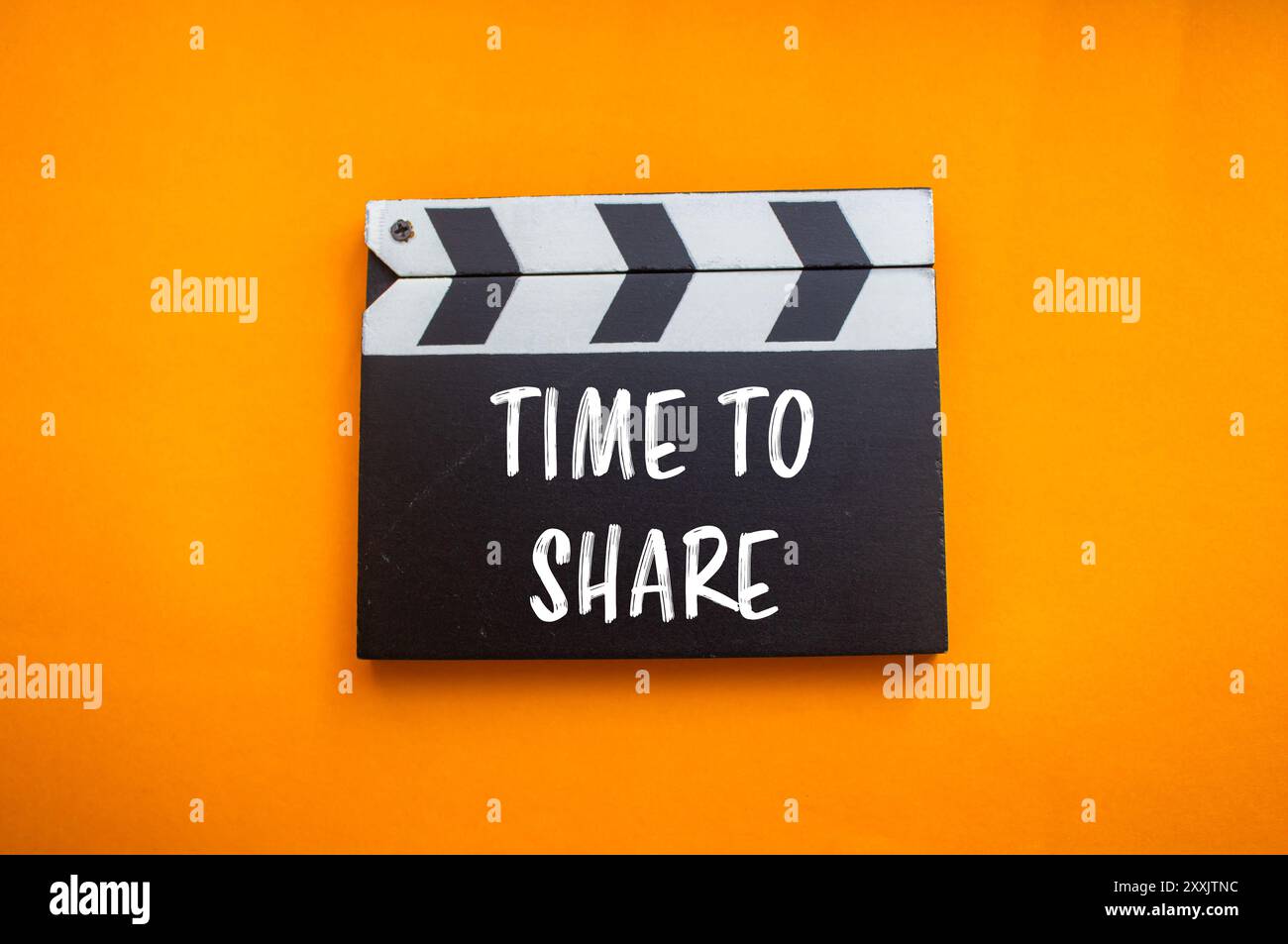 Time to share message written on movie clapper board with orange ...