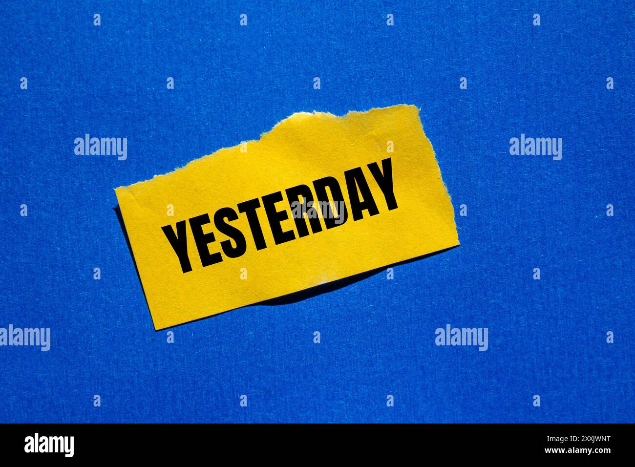 Yesterday message written on ripped torn yellow paper piece with ...