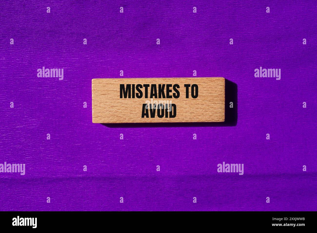 Mistakes to avoid message written on wooden blocks with purple ...