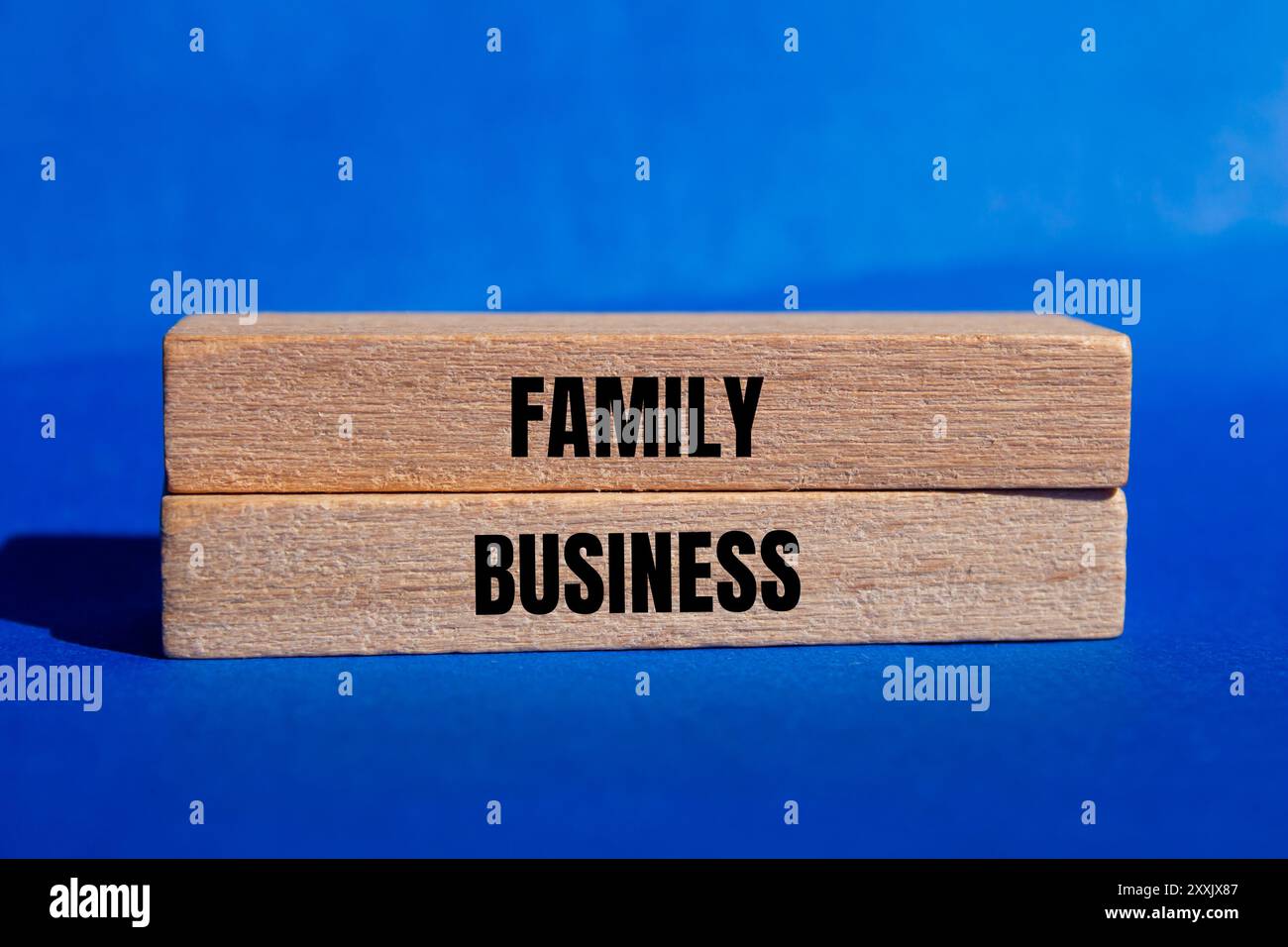 Family business message written on wooden blocks with blue background ...