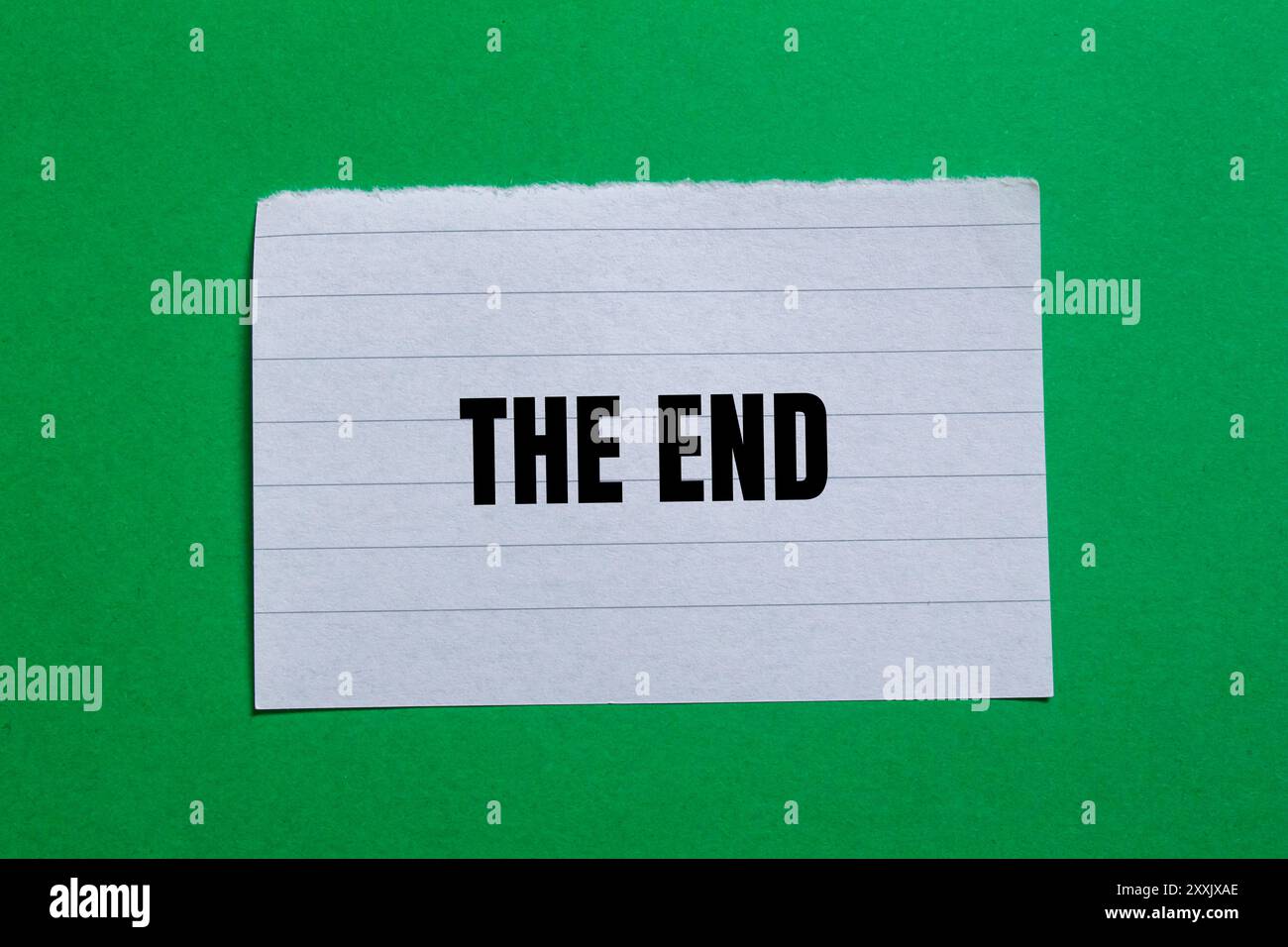 The end message written on ripped torn paper piece with green ...