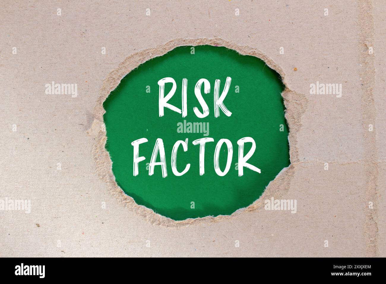 Risk factor message written on ripped torn paper with green background ...