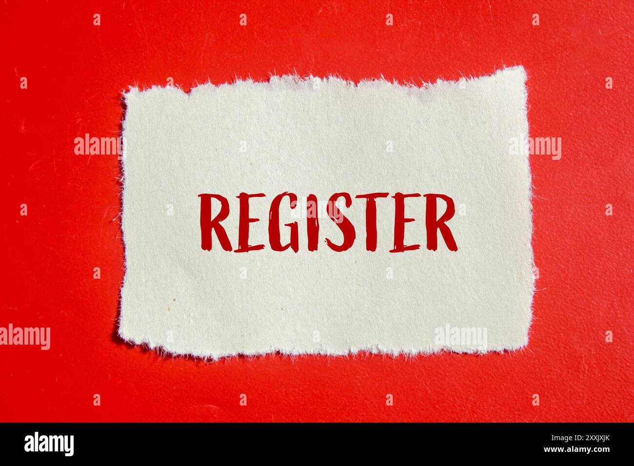Register message written on ripped torn paper piece with red background. Conceptual register ...