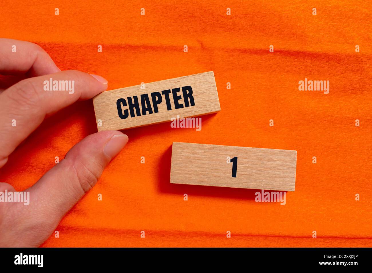 Chapter 1 message written on wooden blocks with orange background ...