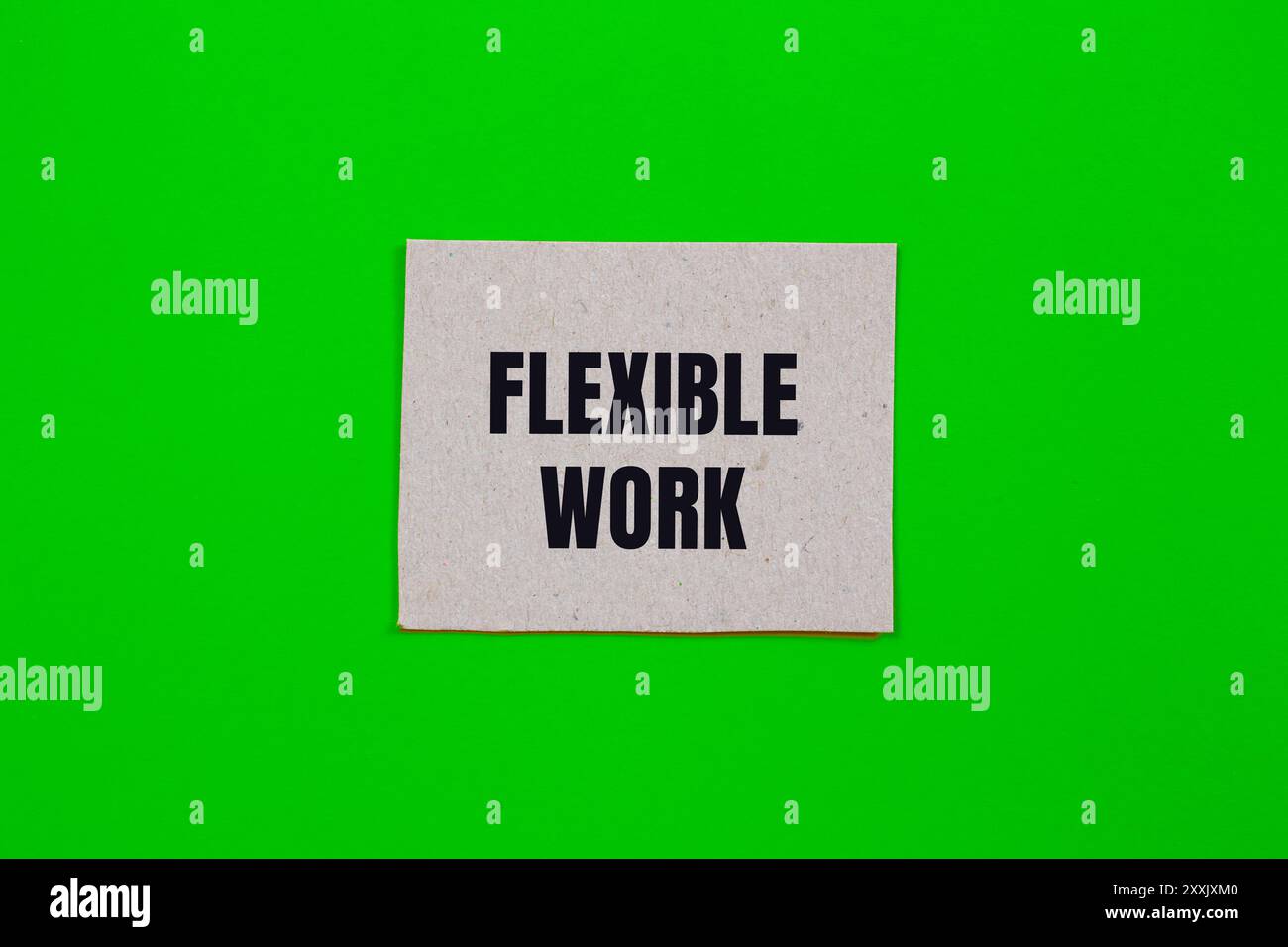 Flexible work message written on paper piece with green background ...