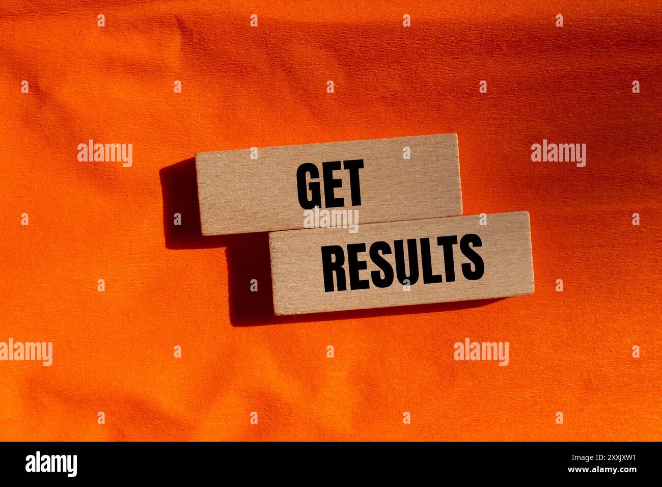 Get results message written on wooden blocks with orange background ...