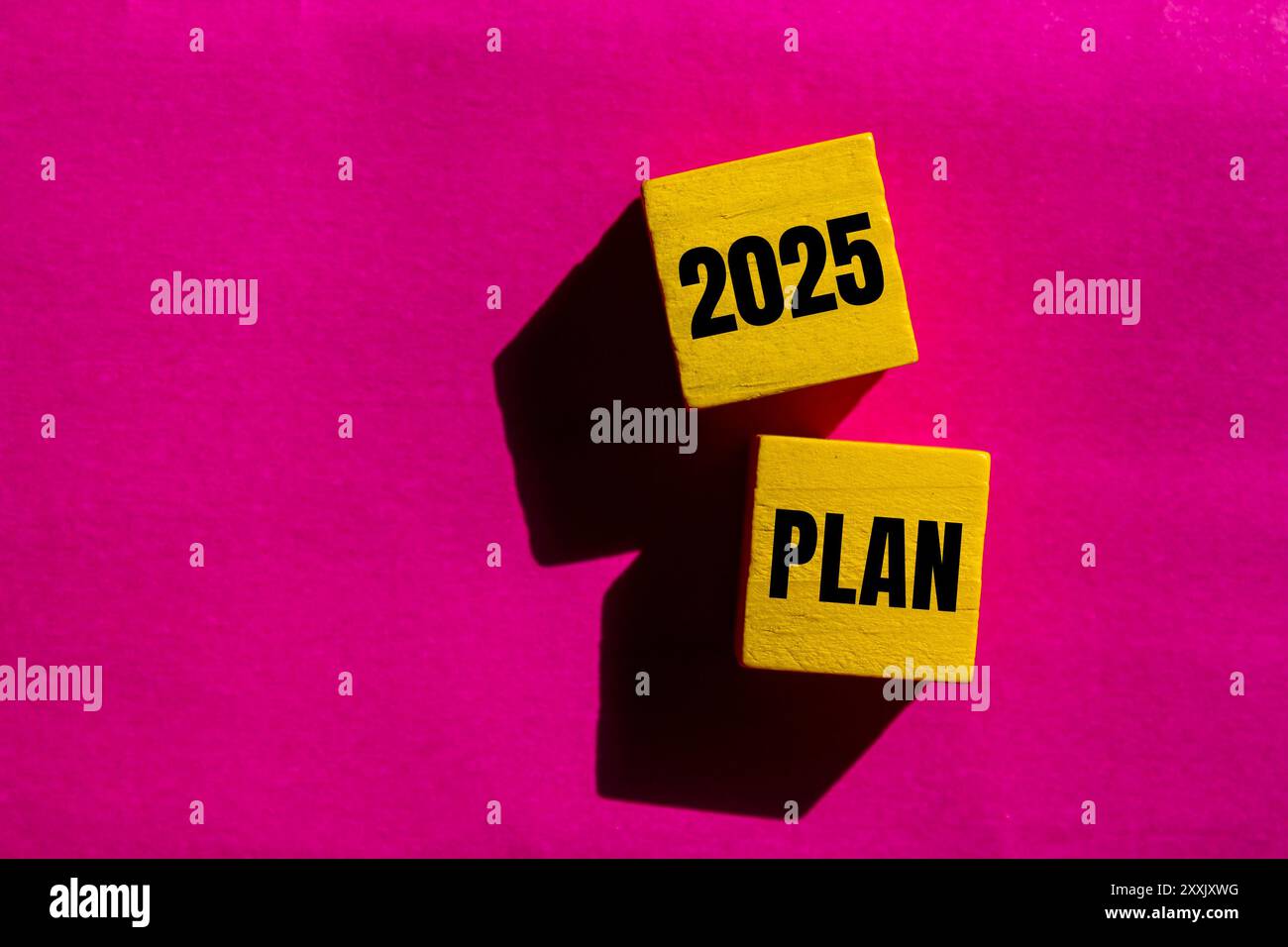 2025 plan message written on yellow wooden cubes with pink background ...