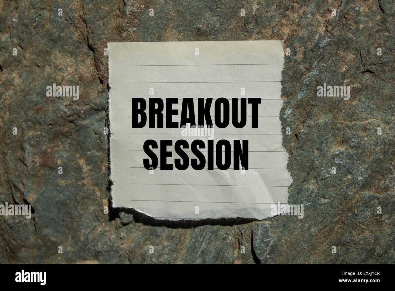 Breakout session message written on ripped torn paper piece with stone ...