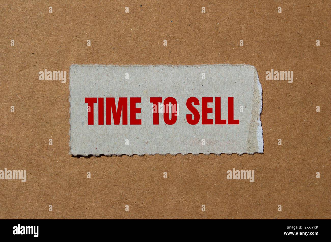 Time to sell message written on ripped torn paper piece with cardboard background. Conceptual ...