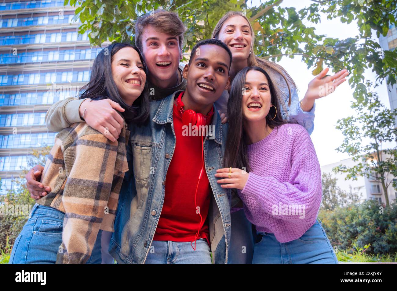 Happy multiethnic group of young friends bonding outdoors Stock Photo - Alamy