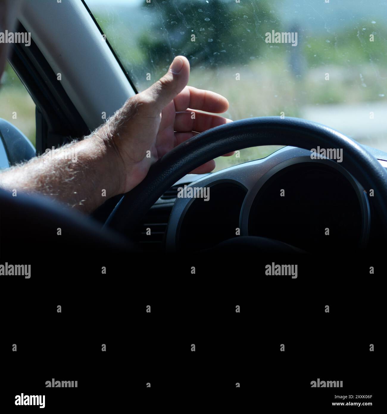 unrecognized person hand on a steering wheel in a car Stock Photo - Alamy