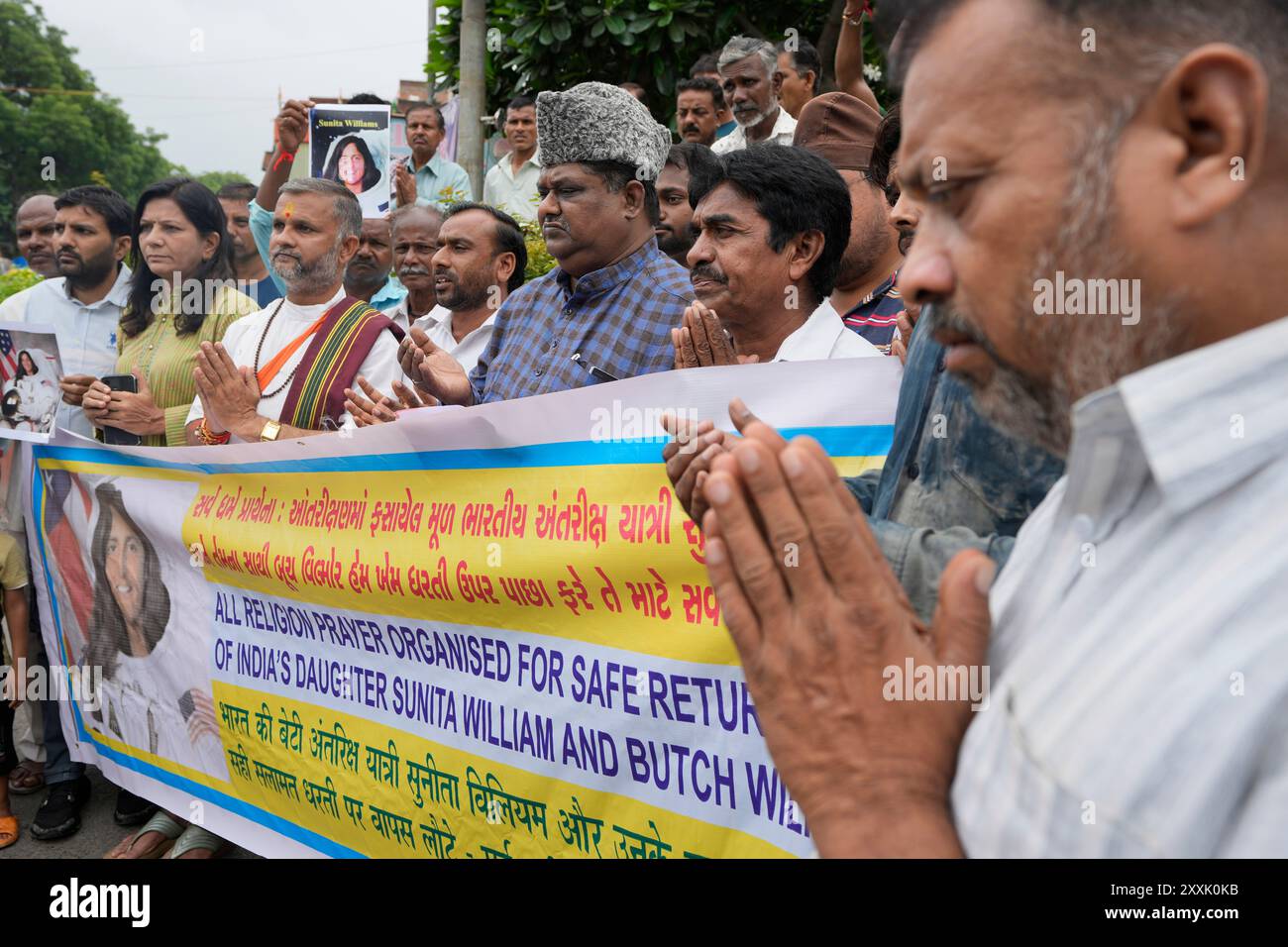 People pray during the all religion prayer for the safe return of ...