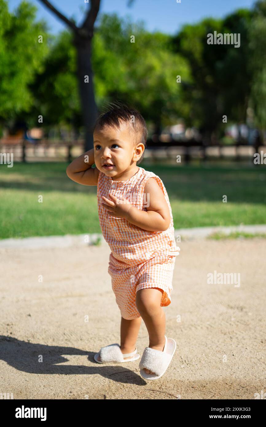 1 year old Latina baby girl taking her first steps outdoors Stock Photo ...
