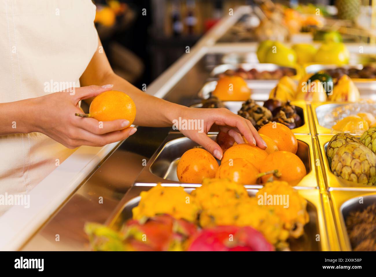 Woman choosing fruits hi-res stock photography and images - Alamy