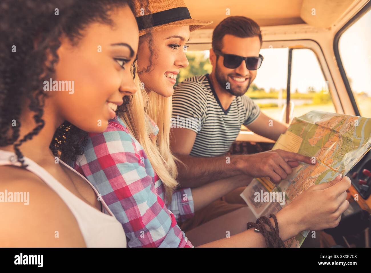 Three young women planning trip hi-res stock photography and images - Alamy