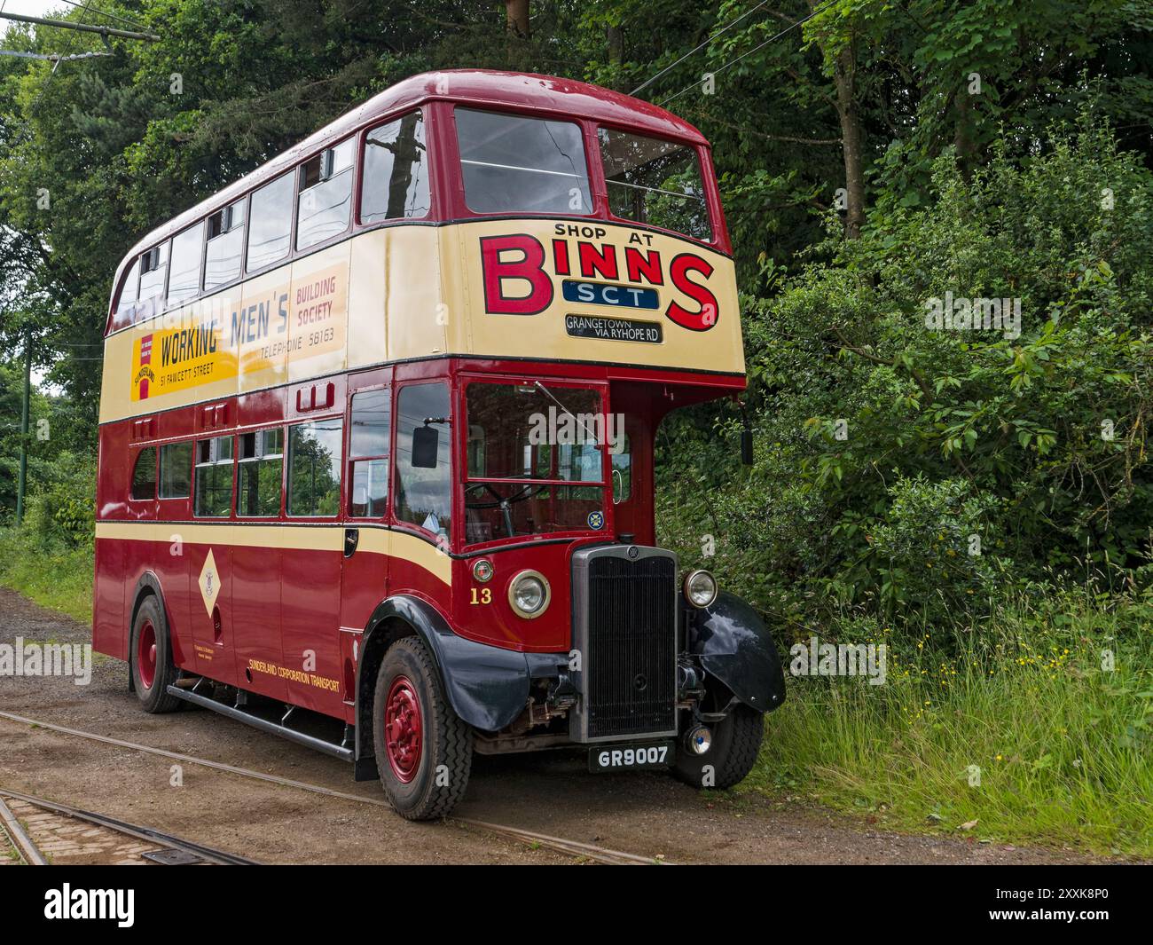 Old red bus with advertisements for businesses in north east England ...