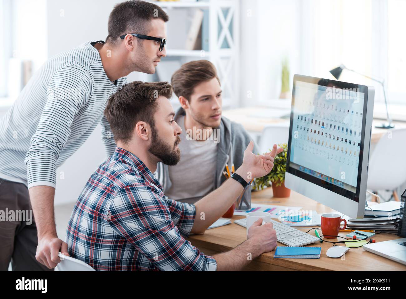 Collaboration is a key to success. Three young business people ...