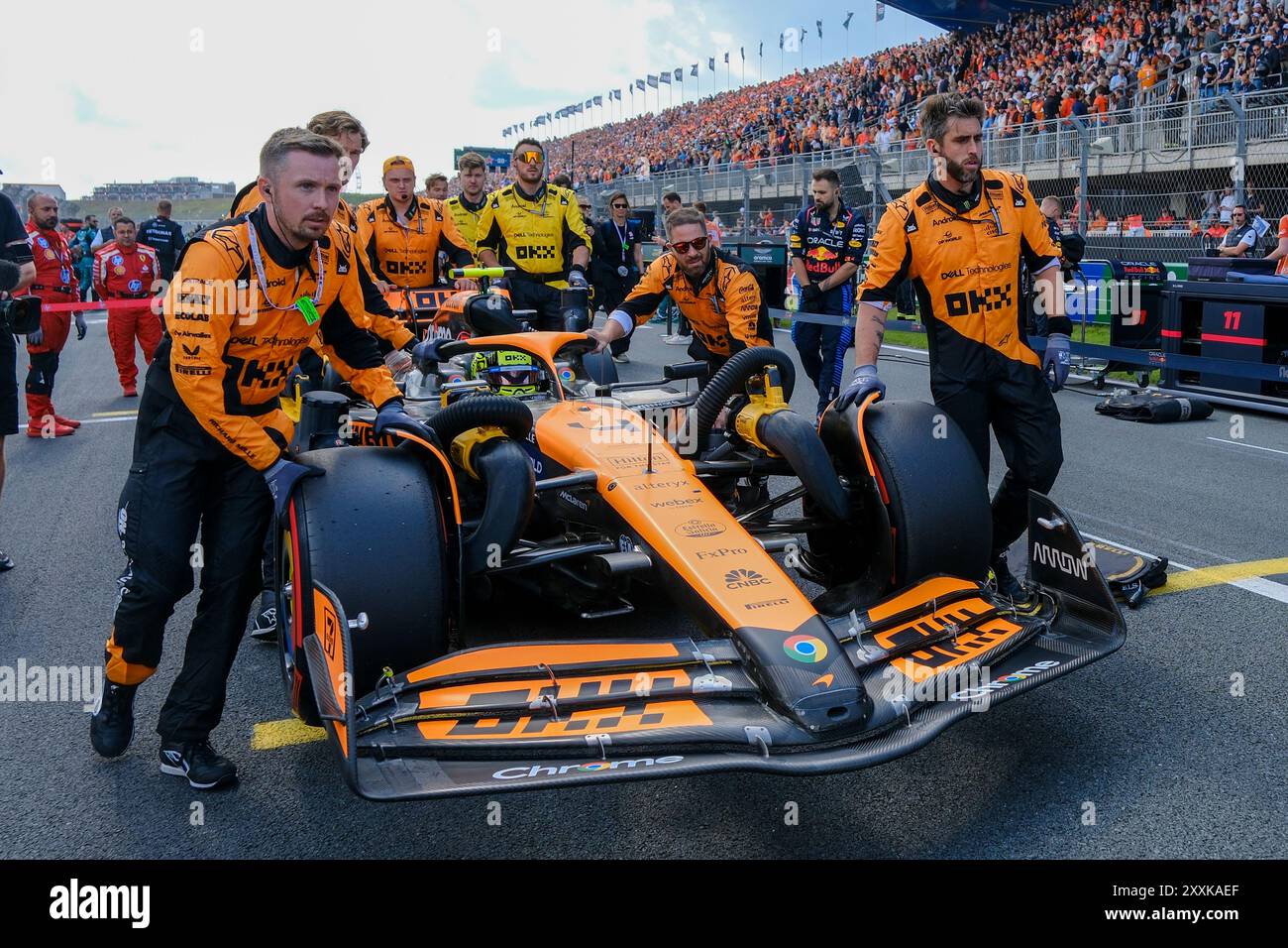 McLaren driver Lando Norris of Britain is pushed to the starting grid ...