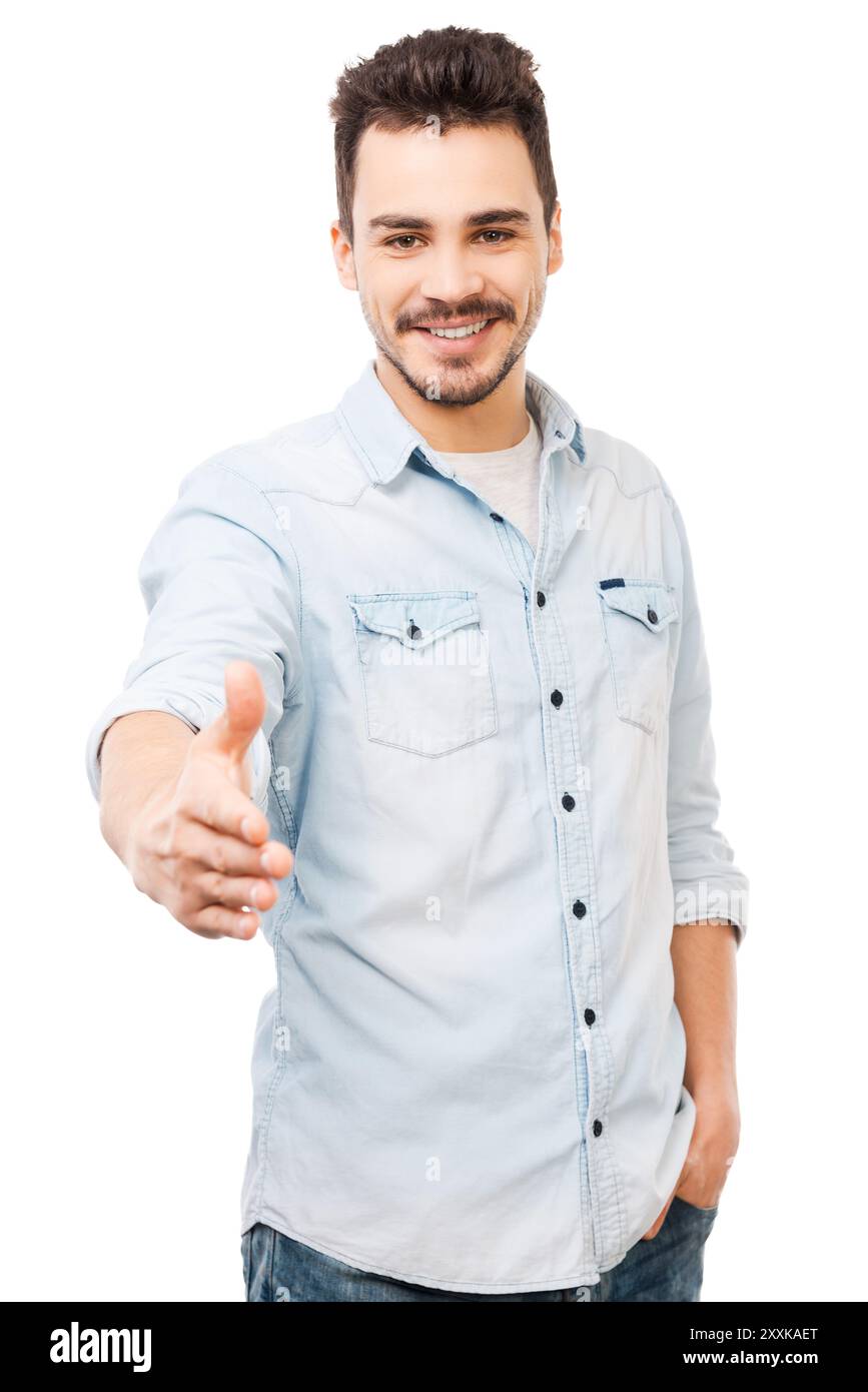 Nice to meet you! Portrait of cheerful young man stretching out hand ...