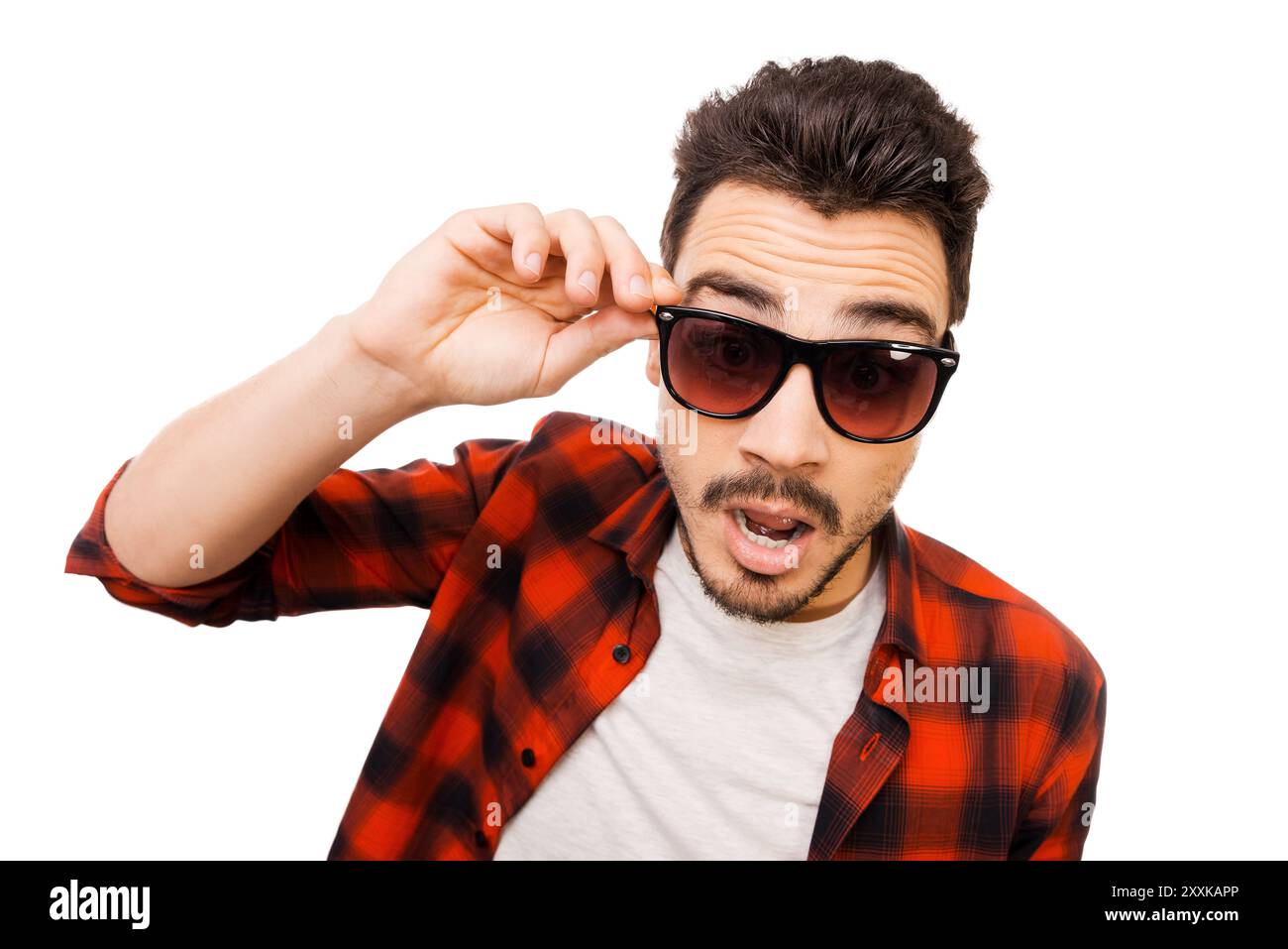 Time to fun! Surprised young man adjusting sunglasses while standing ...