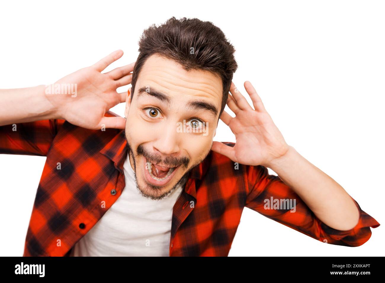 Shocking news. Portrait of surprised young man in shirt smiling while ...