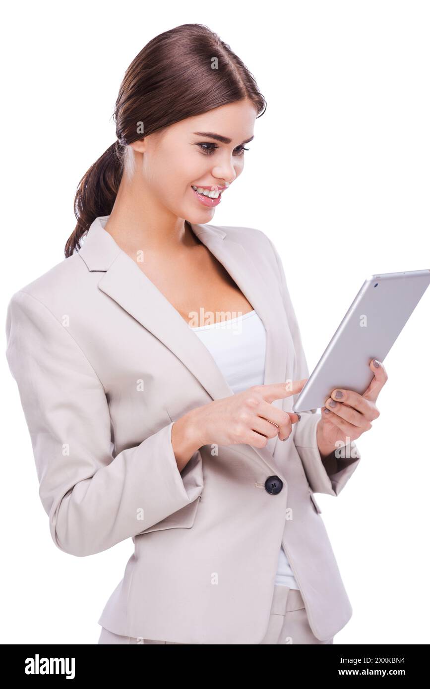Beauty at work. Side view of confident young women holding digital ...