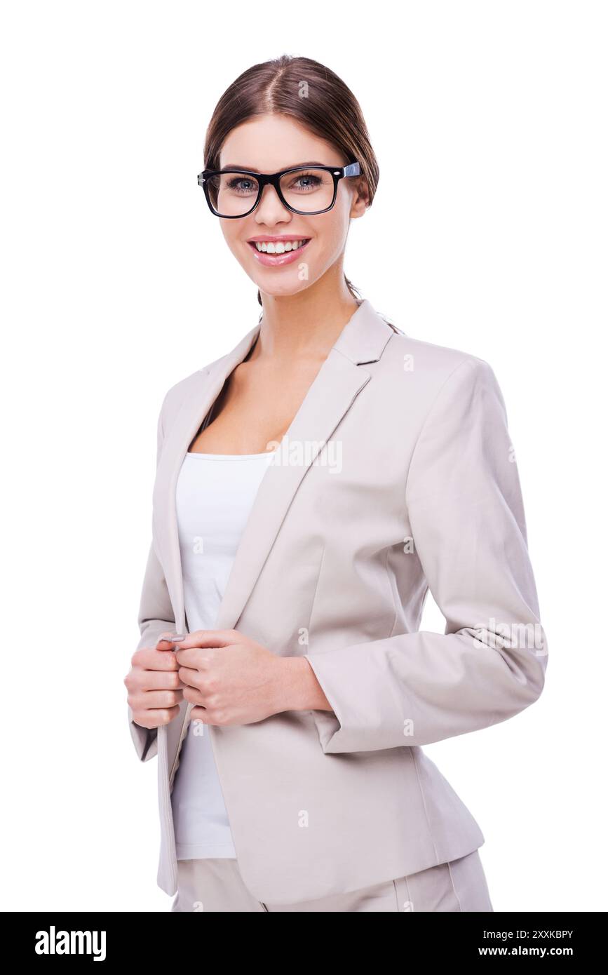 Beautiful and smart. Confident young businesswoman adjusting her jacket ...