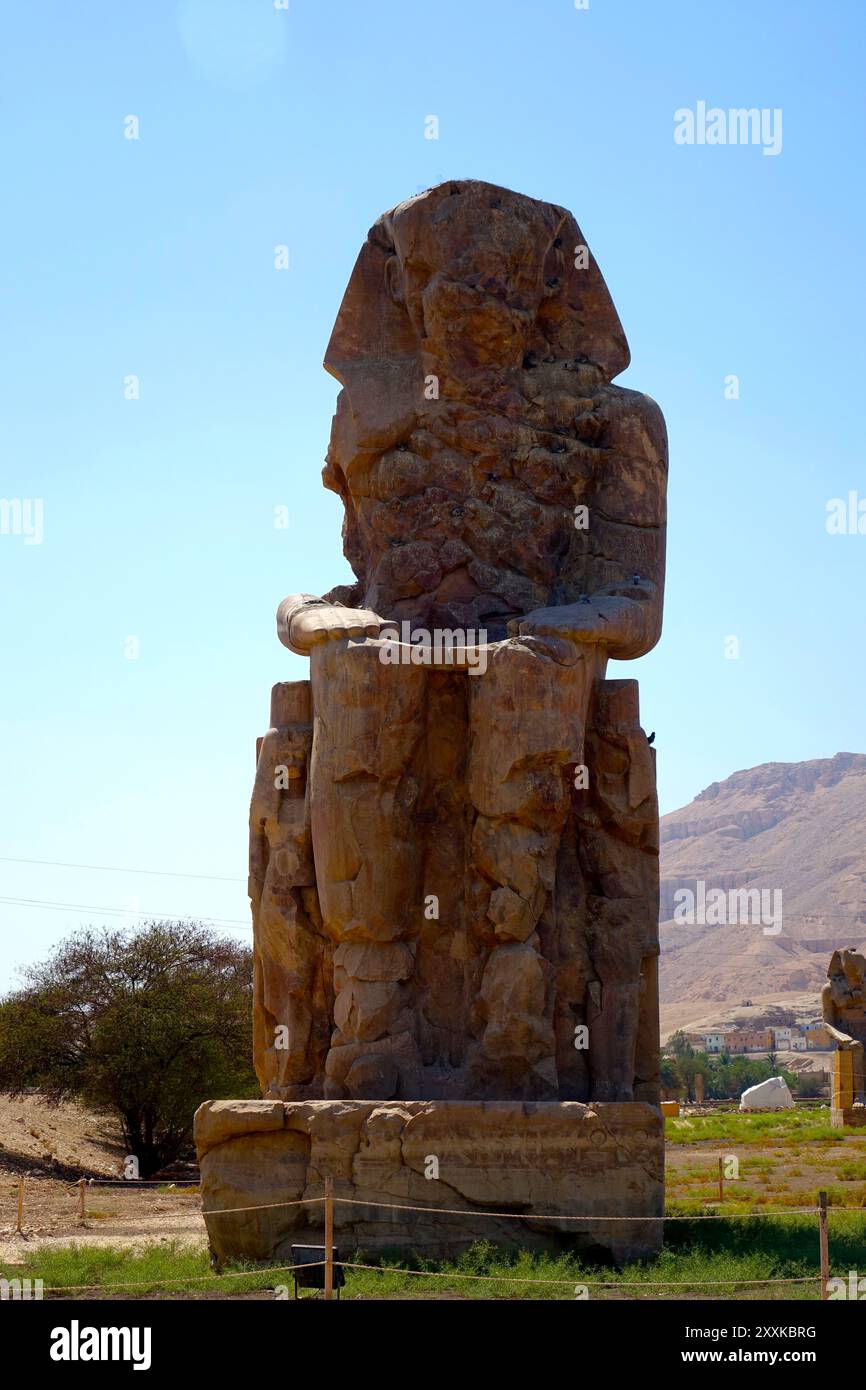 The Colossi of Memnon stand proudly in the West of Egypt, showcasing ...